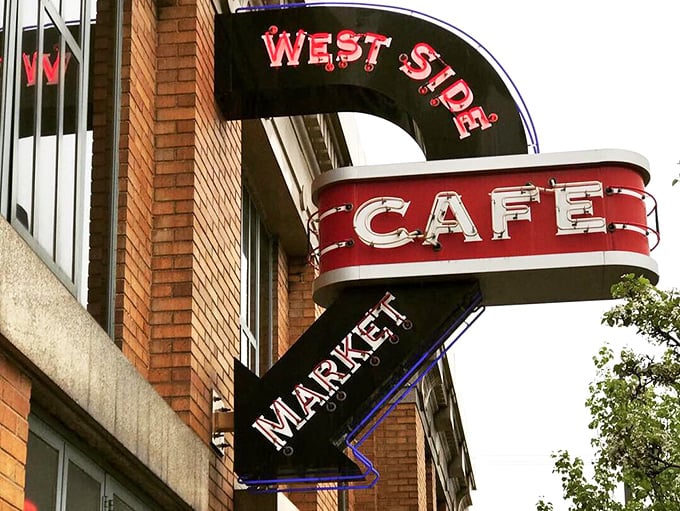 That curved neon sign – a beacon of hope for hungry market-goers since long before food photography was even a thing.