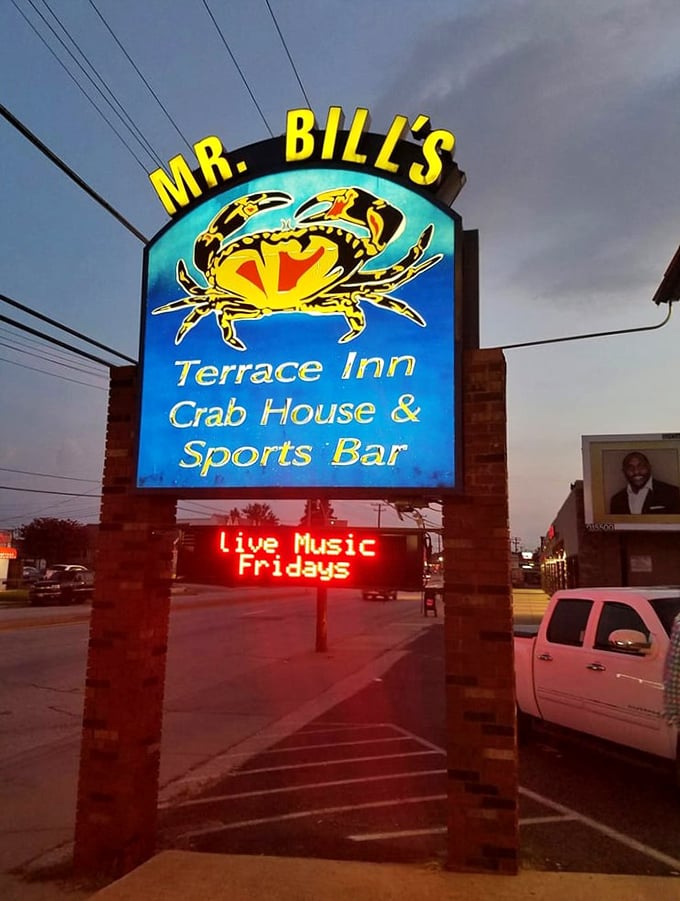 The sign glows against the evening sky, promising live music Fridays and good times every other day.