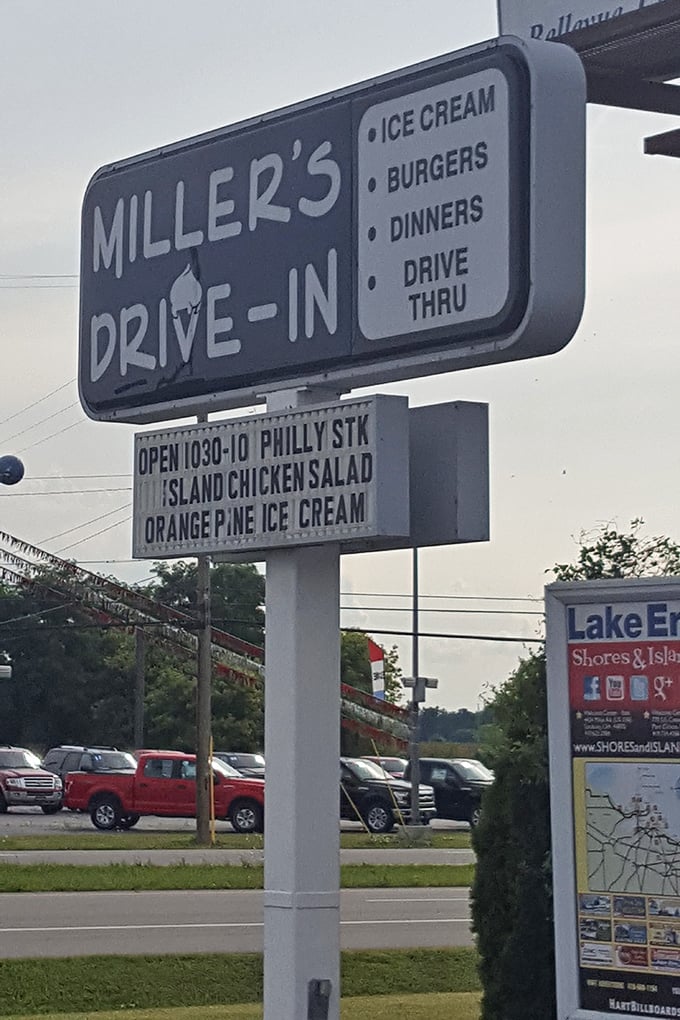 The roadside sign announces daily specials like town crier proclamations—Orange Pine ice cream today, happiness guaranteed all season long.