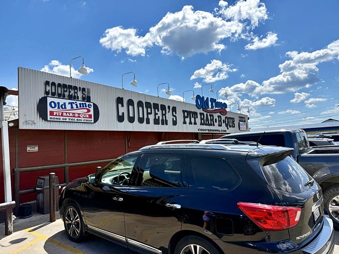 Under brilliant Texas skies, Cooper's sign promises what generations of barbecue lovers know to be true—authentic pit-smoked perfection awaits inside.