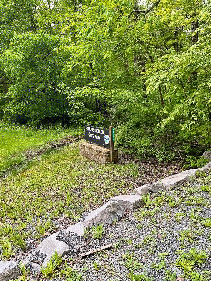 The unassuming entrance sign that marks the boundary between ordinary life and woodland escape. Like finding the door to Narnia, but with better parking options.
