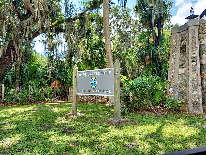 First impressions matter: This understated entrance sign, nestled among native palms, marks the threshold between modern Florida and its storied past.