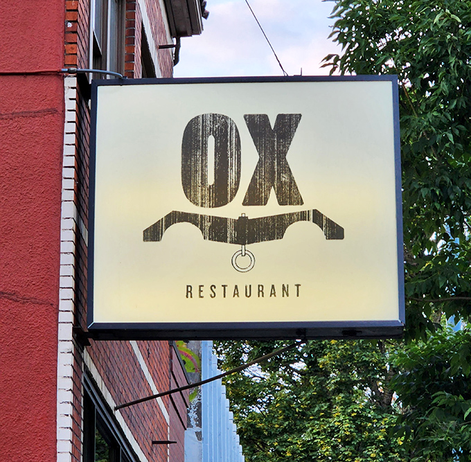 The understated sign outside belies the flavor explosions waiting within—like finding a treasure map disguised as a simple piece of paper.