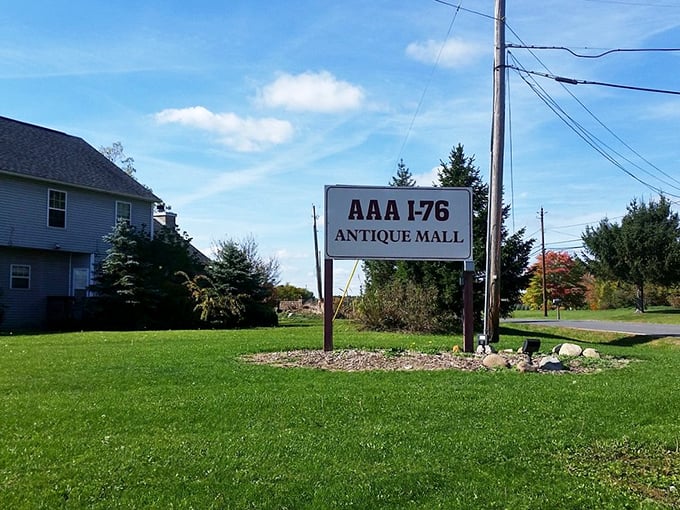 The roadside sign that beckons to interstate travelers—simple, straightforward, and promising adventures in antiquing just a turn away.