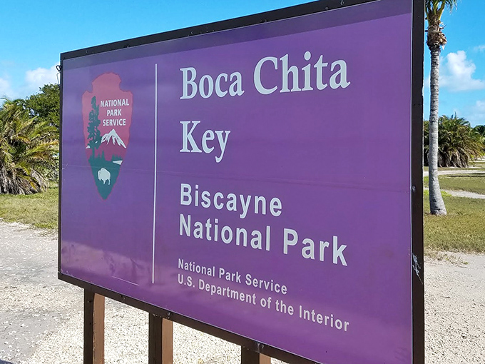 The park's entrance sign promises adventure with government efficiency—the purple backdrop a surprisingly stylish touch from the National Park Service.