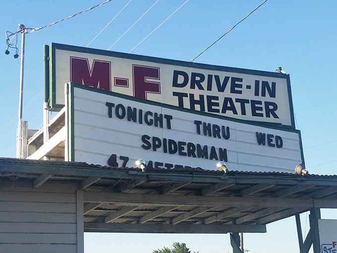 The marquee announces tonight's feature, a modern superhero on a classic screen—proof that some traditions never go out of style.