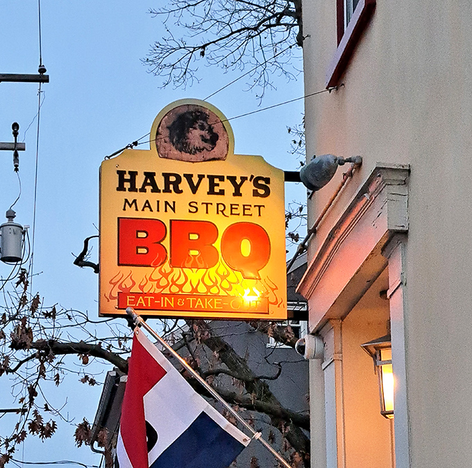Harvey's illuminated sign glows like a beacon in the evening sky – not all heroes wear capes, some just smoke meat to perfection.