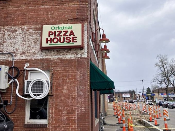 No fancy marketing needed – just a straightforward sign promising "Original Italian Style Pizza" that delivers precisely what it advertises.