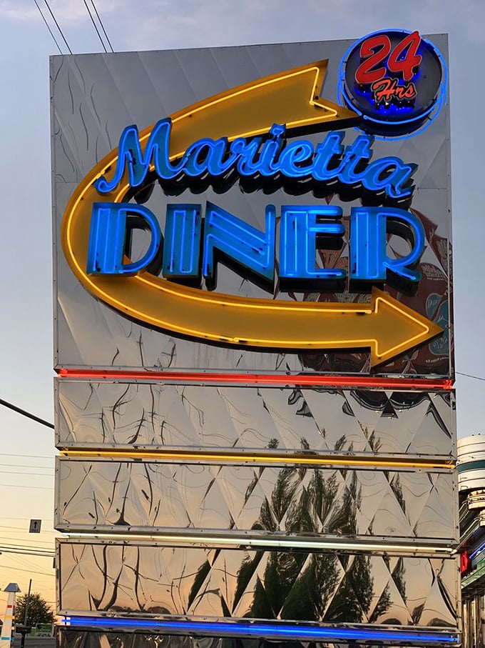 The iconic neon sign shines like a lighthouse for the hungry, that "24 Hours" promise more comforting than a lullaby when midnight cravings strike.