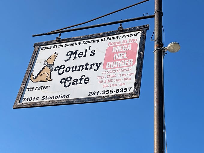 The roadside sign featuring Mel's howling coyote logo—a beacon of hope for the hungry traveler and a promise of homestyle satisfaction.