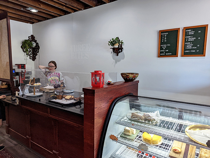 Behind the counter magic where flour transforms into joy. The display case holds treasures more valuable than gold—at least to your taste buds.