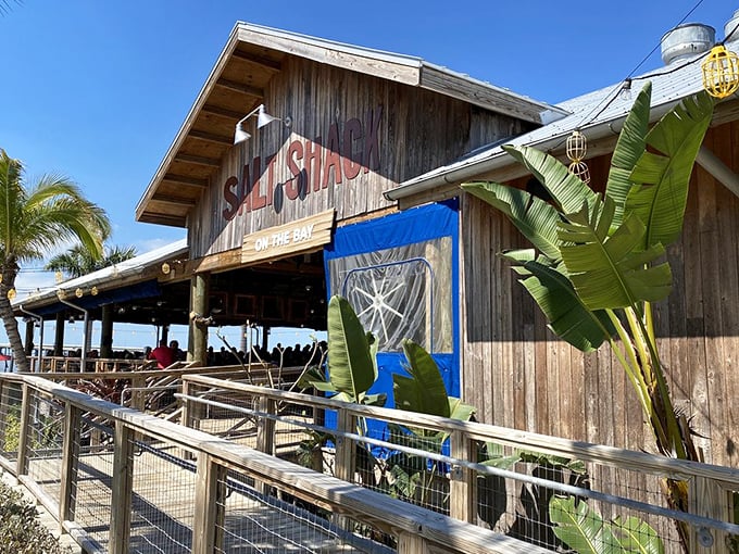 The Salt Shack's weathered wooden exterior isn't trying to be Instagram-worthy—it just can't help itself. Those banana leaves add the perfect tropical accent.
