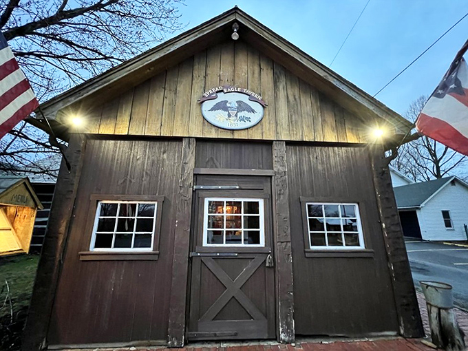 As evening falls, the tavern's wooden façade glows with welcome, the Spread Eagle emblem promising both history and hospitality behind those doors.