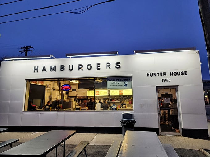 As dusk falls, the illuminated Hunter House beckons like a white beacon of burger bliss—a midnight mirage for the hungry night owls of Birmingham.