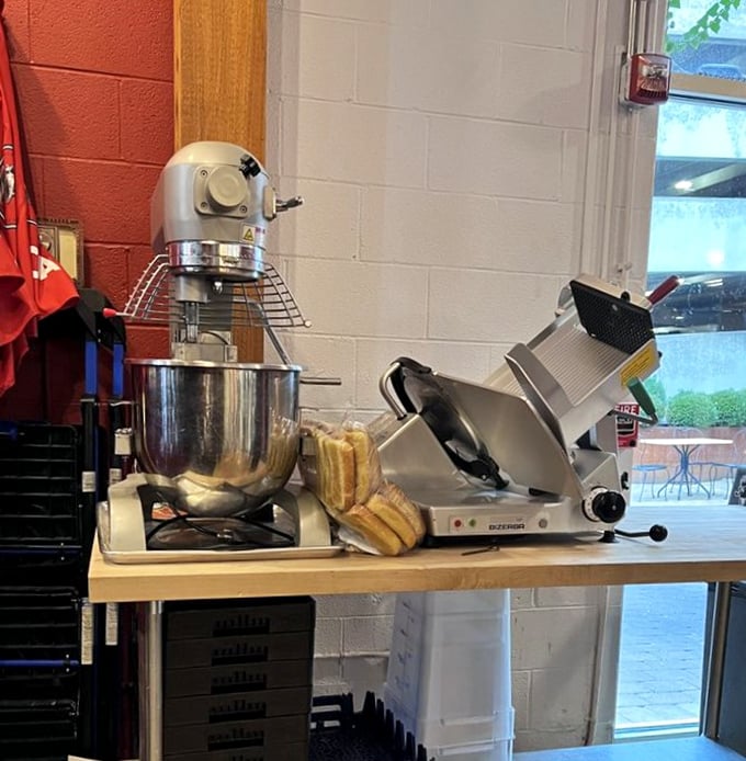 The tools of the trade: professional equipment for serious sandwich business. That meat slicer has probably seen more action than most Hollywood stunt doubles.