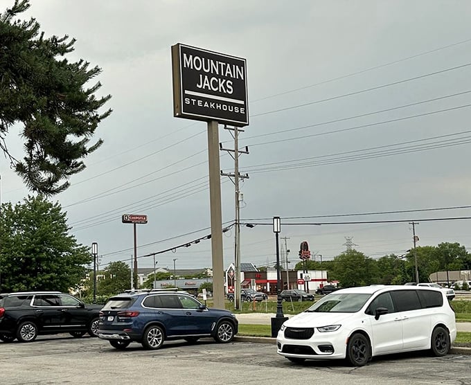 The roadside sign stands tall like a beacon of hope for hungry travelers: civilization, and more importantly, excellent steak, lies ahead.