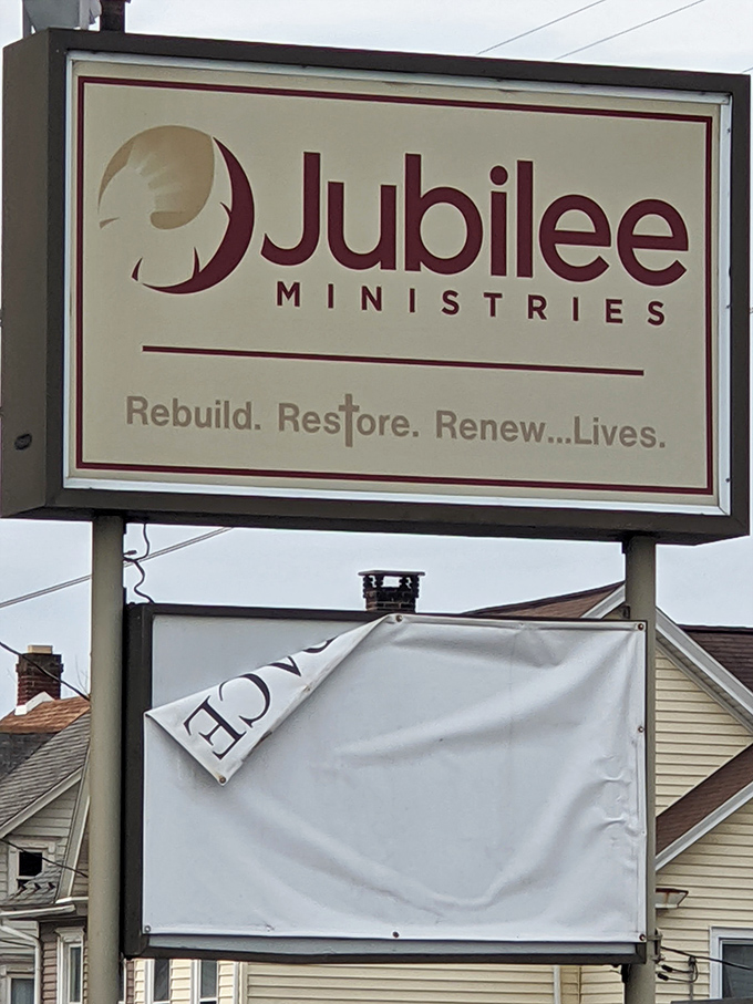 The Jubilee Ministries sign reveals the mission behind the merchandise—a reminder that your bargain hunting supports community programs with every purchase.