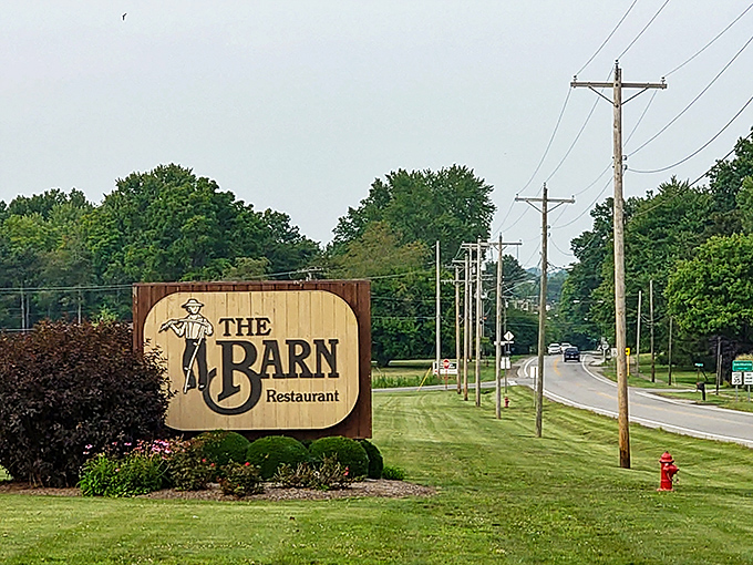 This roadside sign doesn't just mark a restaurant – it's a promise of the hearty, homestyle meal waiting just beyond those barn doors.