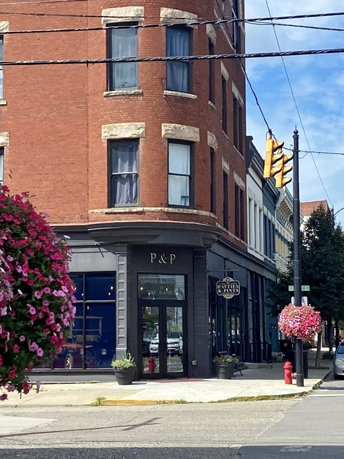 Corner location, hanging flower baskets, and historic charm – the trifecta of curb appeal. This street view promises the quintessential small-town dining experience with big-city flavor.