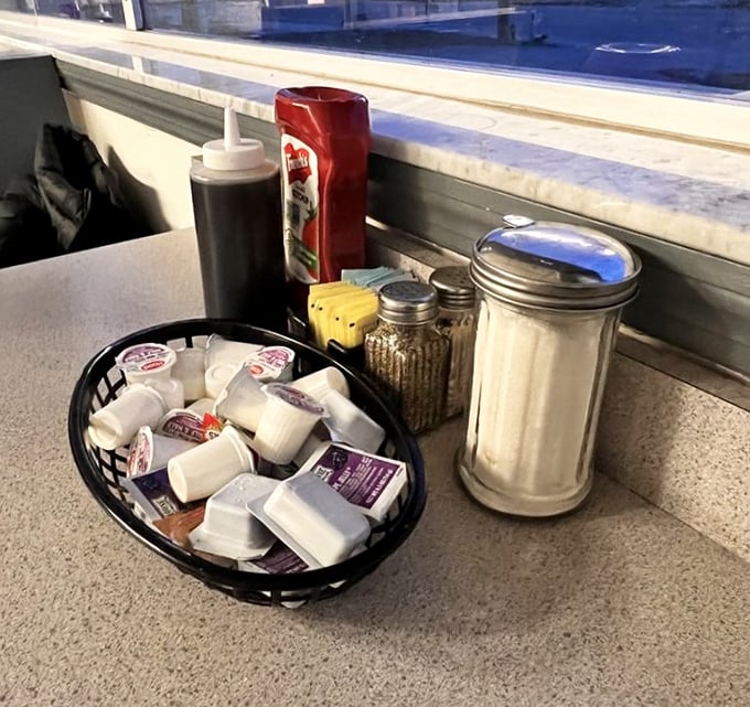 The classic diner table setup—sugar, creamer, and condiments standing at attention, ready to transform your breakfast from great to transcendent.