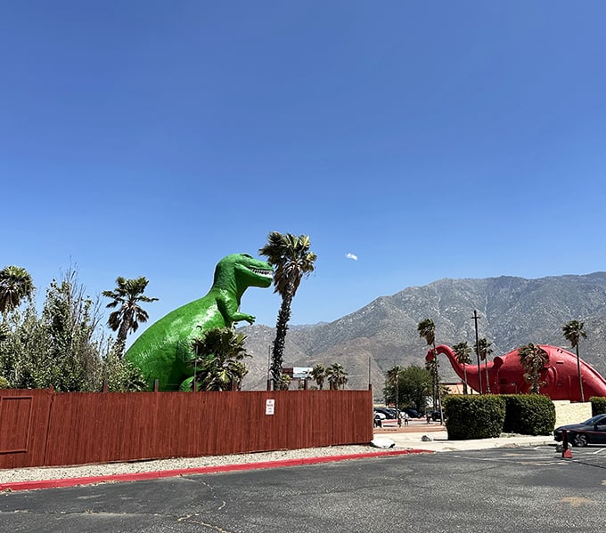 The classic view that's stopped traffic for decades – Dinny and Mr. Rex facing off across the parking lot like old friends.