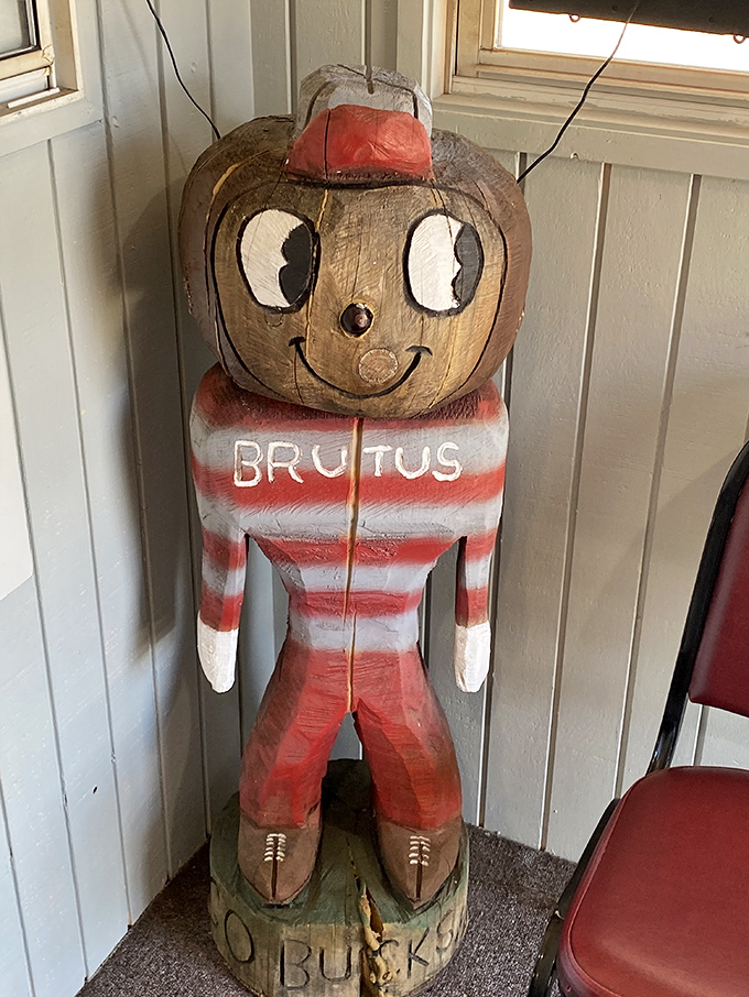Brutus Buckeye stands guard in wooden form—a quirky touch of local pride watching over sandwich-seekers with his perpetual smile.