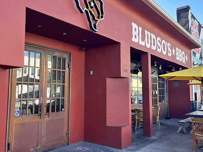 The bright red exterior of Bludso's Bar & Que promises Texas-sized flavor in the heart of Los Angeles. Smoke signals of deliciousness ahead!