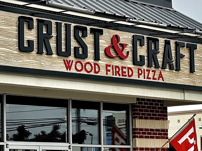 The rustic wooden sign at Crust & Craft promises wood-fired perfection. That ampersand isn't just punctuation—it's a delicious commitment.