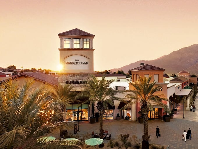 Desert Hills Premium Outlets at sunset – where bargain hunting meets vacation vibes under those swaying palm trees and golden skies.