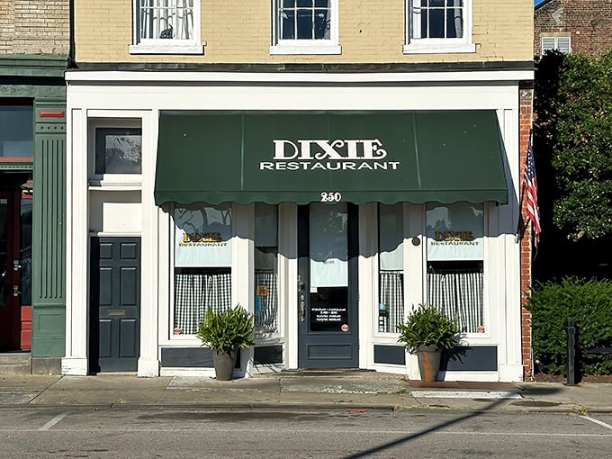 The classic green awning of Dixie Restaurant beckons like a friendly wave, promising comfort food and conversations that matter. 