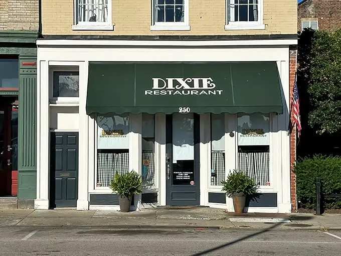 The classic green awning of Dixie Restaurant beckons like a friendly wave, promising comfort food and conversations that matter. 