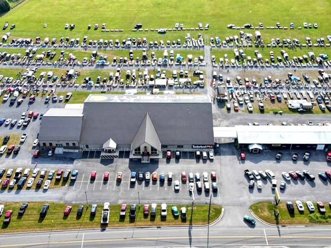 Aerial view of Leighty's Flea Market showing hundreds of cars and a massive shopping complex. Treasure hunting on an industrial scale!