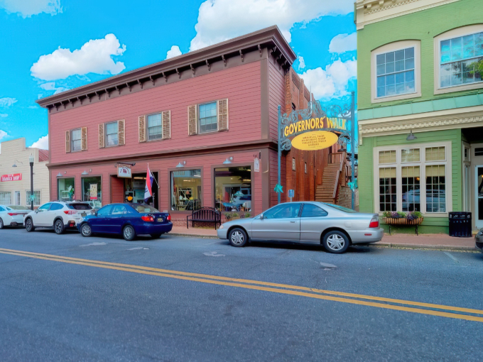 Governor's Walk in Milton invites you with its cheerful yellow sign and historic brick buildings – small-town charm at its finest!
