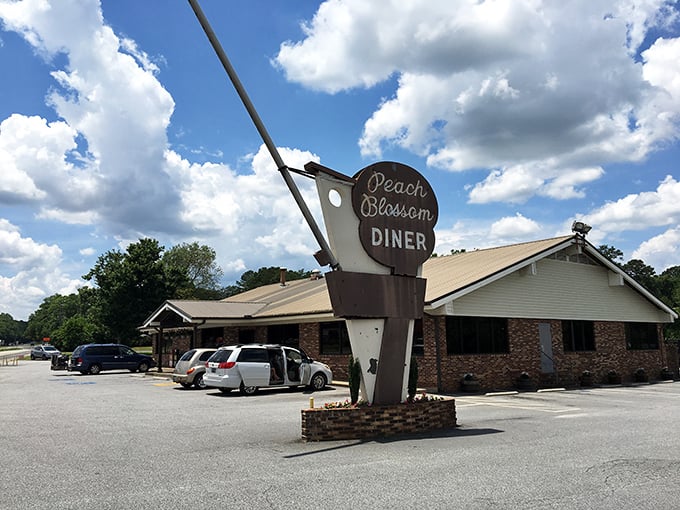 The iconic Peach Blossom Diner sign stands tall against a blue Carolina sky, promising comfort food and nostalgia by the plateful.