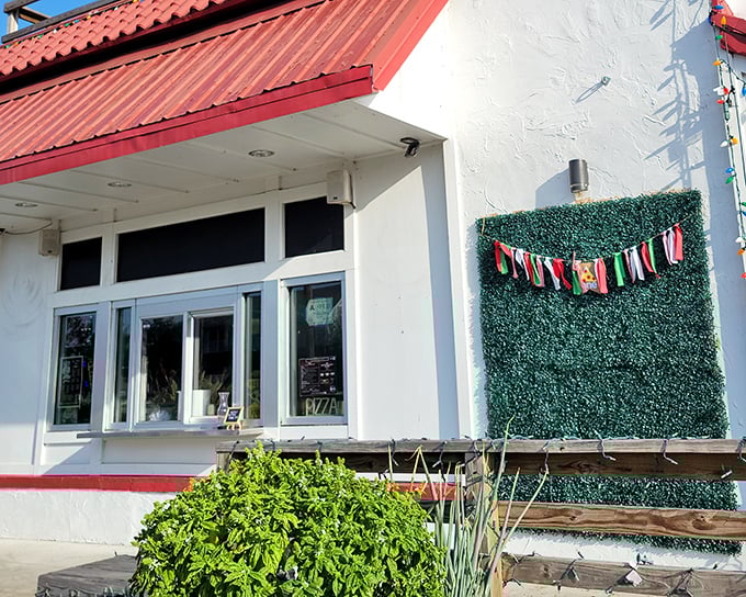 The charming exterior of Don Luca beckons with its red roof and white walls – pizza paradise hiding in plain sight!