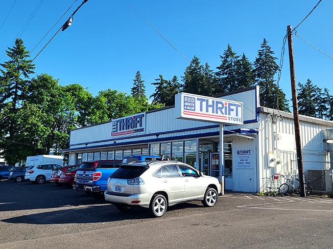 The Red White & Blue Thrift Store stands proudly under Oregon skies, a blue-and-white treasure chest waiting to be unlocked by bargain hunters.