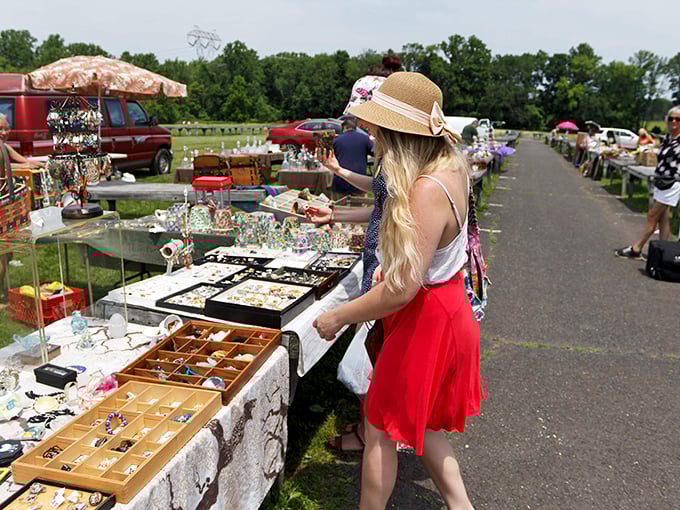 Treasure hunting at its finest! A shopper in a straw hat browses jewelry displays at Rice's Market, where one person's castoffs become another's prized possessions.