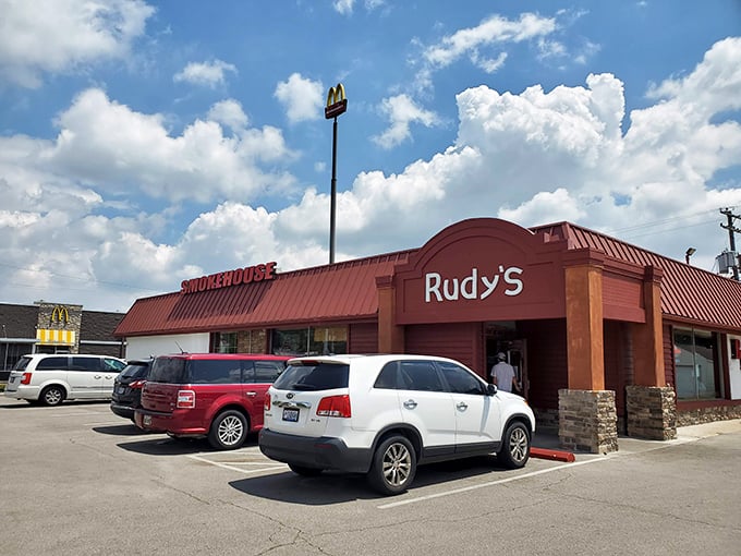 Rudy's Smokehouse exterior beckons with its bold red roof – like a barbecue lighthouse guiding hungry souls to smoky paradise.
