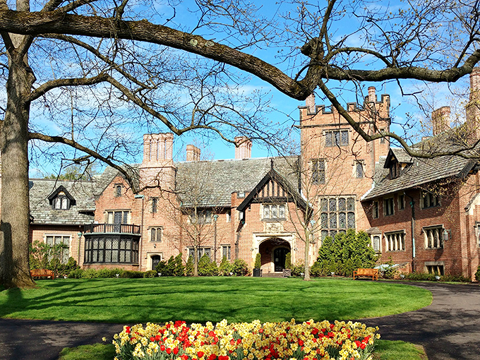 Stan Hywet Hall stands majestically against the blue sky, its Tudor architecture making you wonder if you accidentally drove to England instead of Akron.
