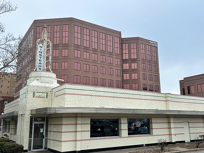 The iconic Winstead's sign stands tall against the Kansas City skyline, a beacon for burger lovers since the golden age of drive-ins.