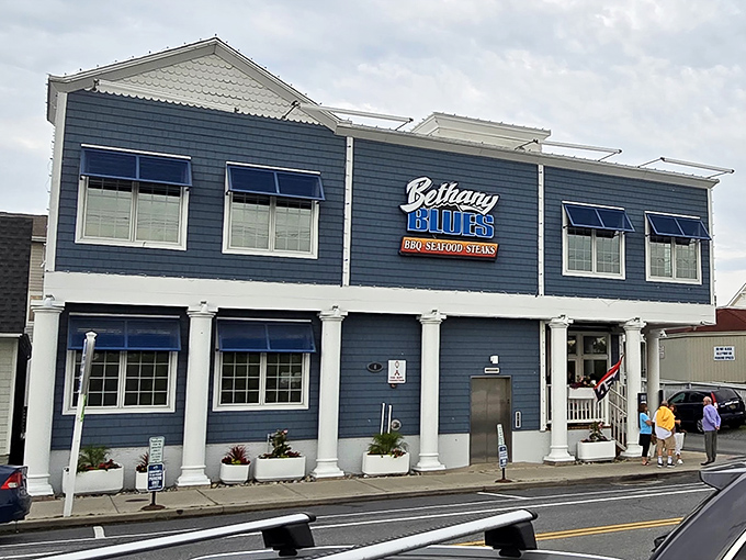Coastal charm with a side of smoke! Bethany Blues' inviting façade promises a delicious escape from ordinary beach food.