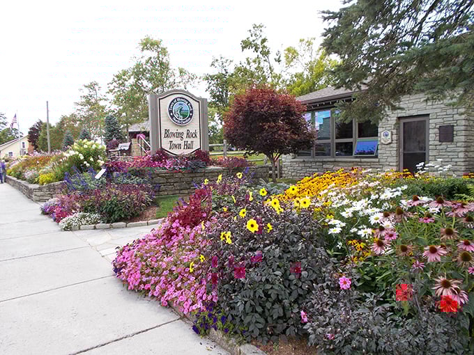 Blowing Rock's flower-lined entrance welcomes visitors like a warm hug from nature itself.