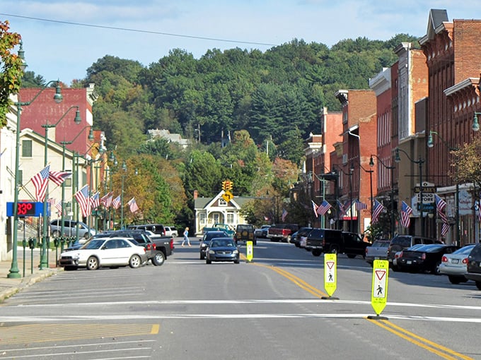 Main Street Brookville, where the hills cradle the town and American flags flutter like friendly waves from the locals.