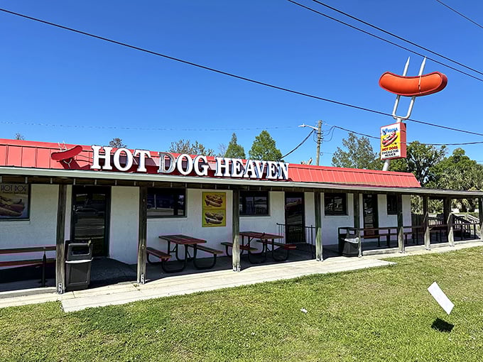 Simple white building, red roof, big dreams - sometimes the best hot dogs hide in plain sight.