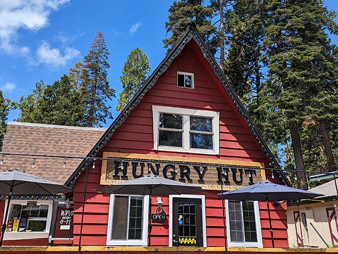 This charming red cabin isn't just a feast for the eyes – inside, they're serving up burgers that make the winding mountain drive completely worth it.