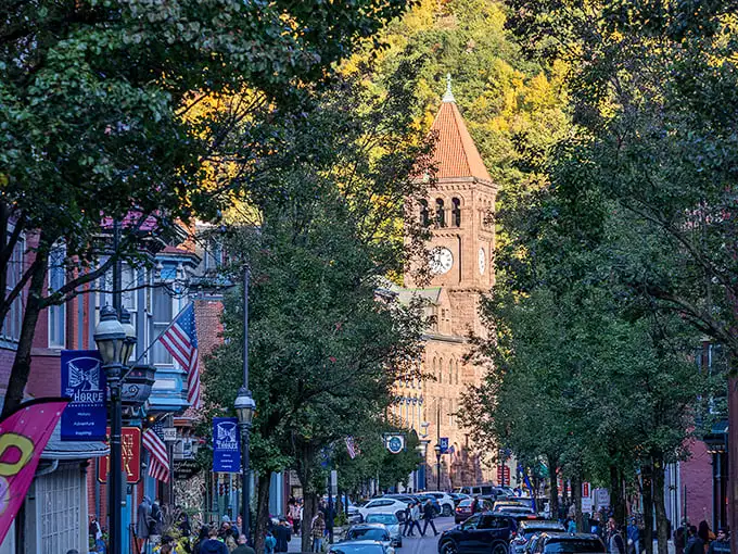 Where history meets autumn glory! Jim Thorpe's iconic clock tower stands sentinel over a street that looks like a Norman Rockwell painting come to life.
