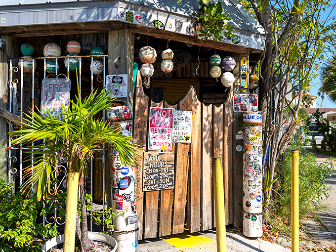Every surface tells a story here – from fishing buoys to handwritten signs, it's Florida folk art at its finest.