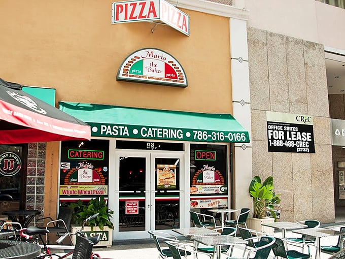 That green awning beckons like a beacon for pizza pilgrims seeking authentic Italian flavors.