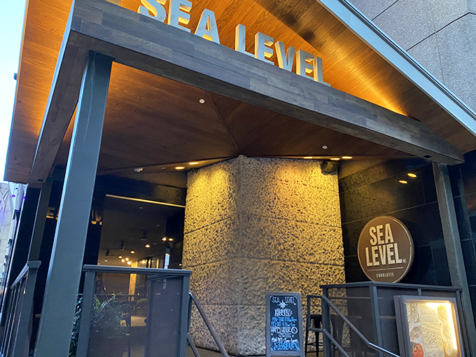 That glowing "Sea Level" sign isn't just a name—it's a promise of coastal treasures served miles from any beach.