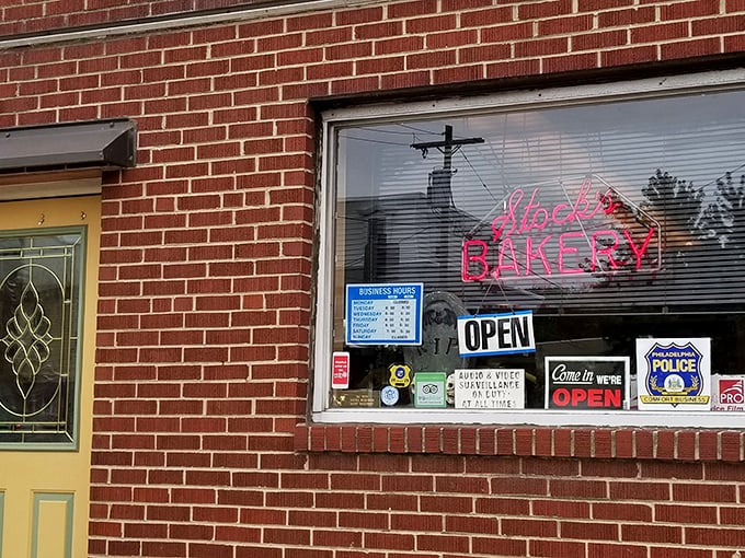 Stock's neon sign glows like a lighthouse for the sweet-toothed. That yellow door might as well be the pearly gates to pastry heaven.